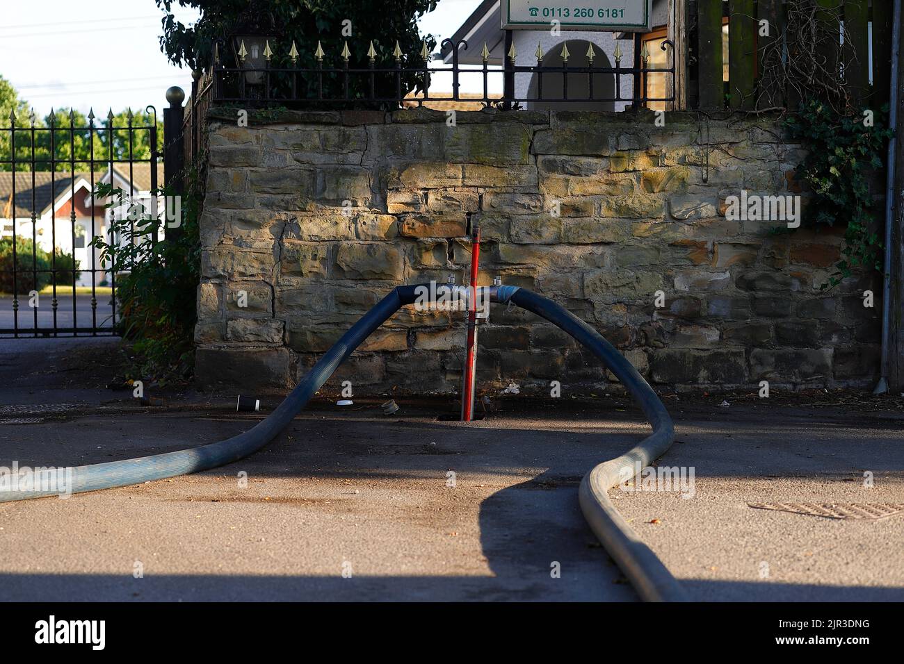 Fire hydrant with 2 hoses attached & being used to supply water to ...