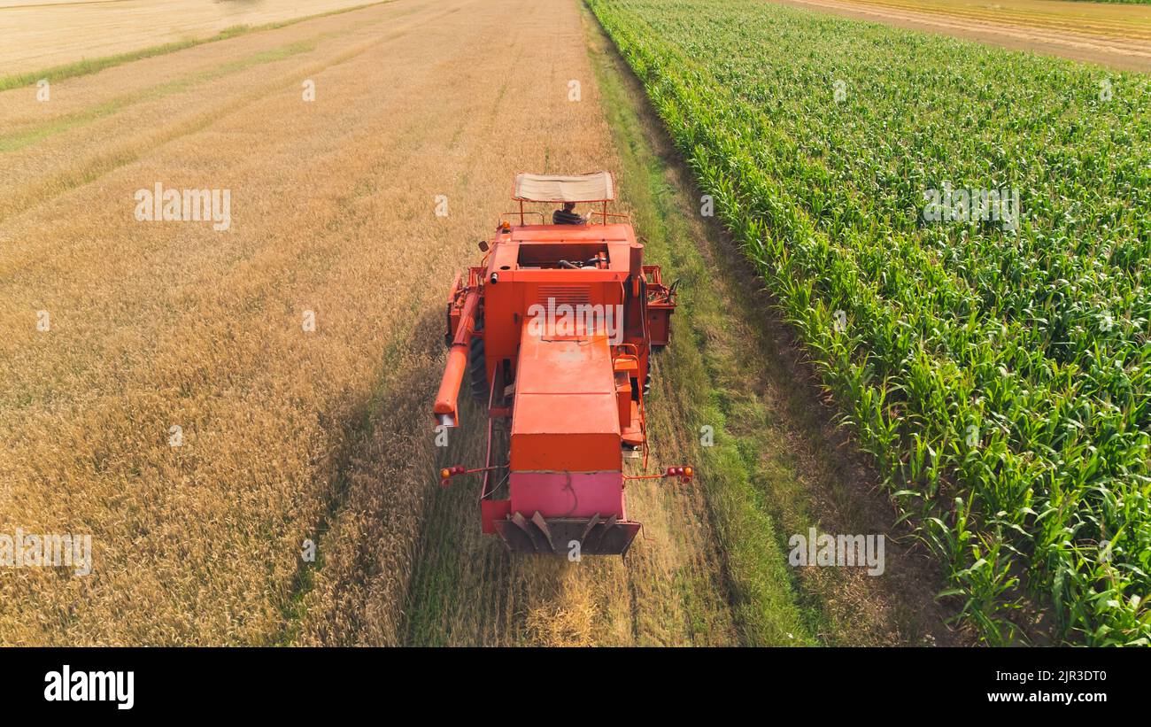 Bird's eye perspective over red combine harvester or other agricultural ...