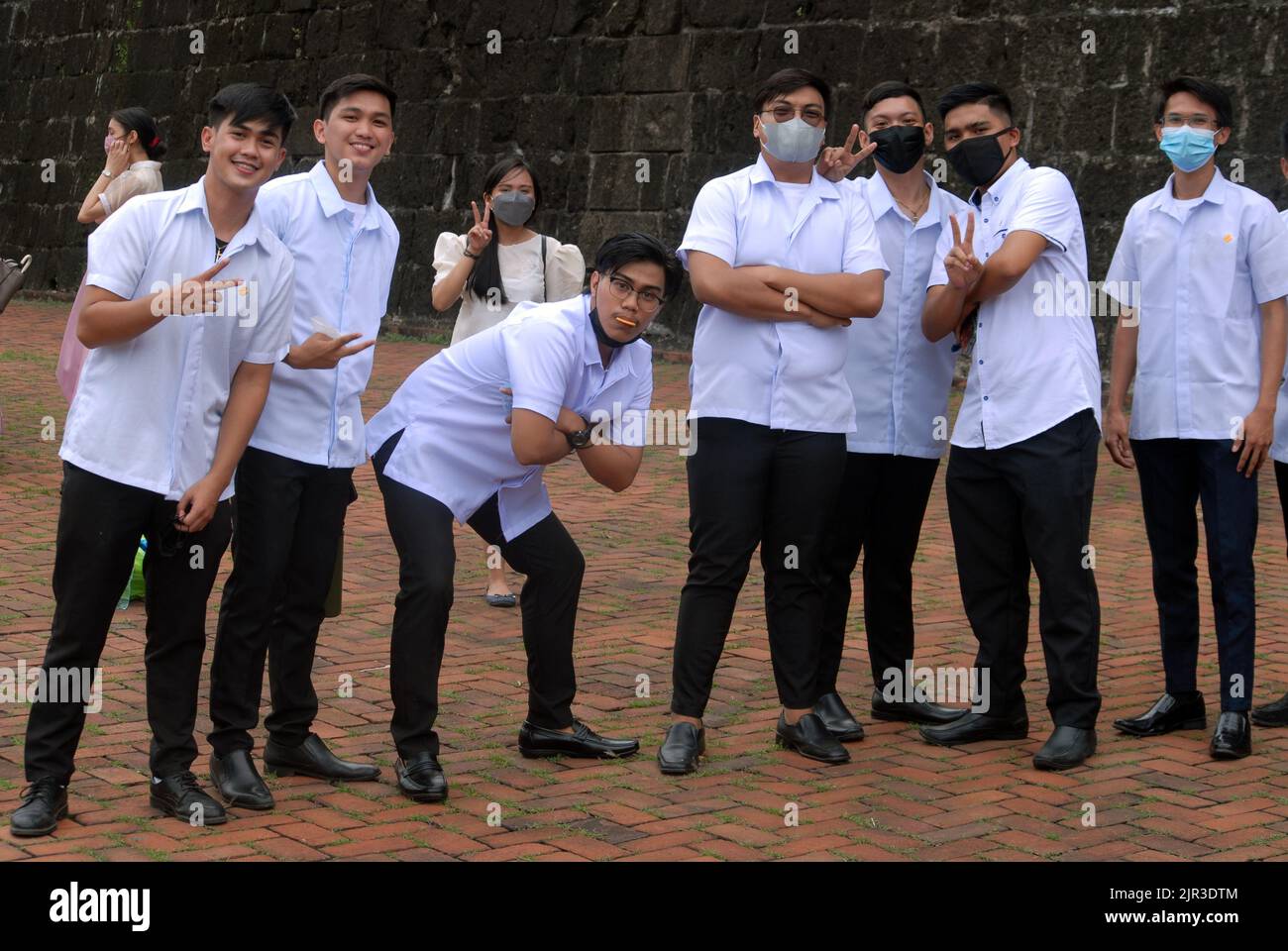 Young Philippine men with masks pose for the camera, Fort Santiago, Manila, Luzon, Philippines ...