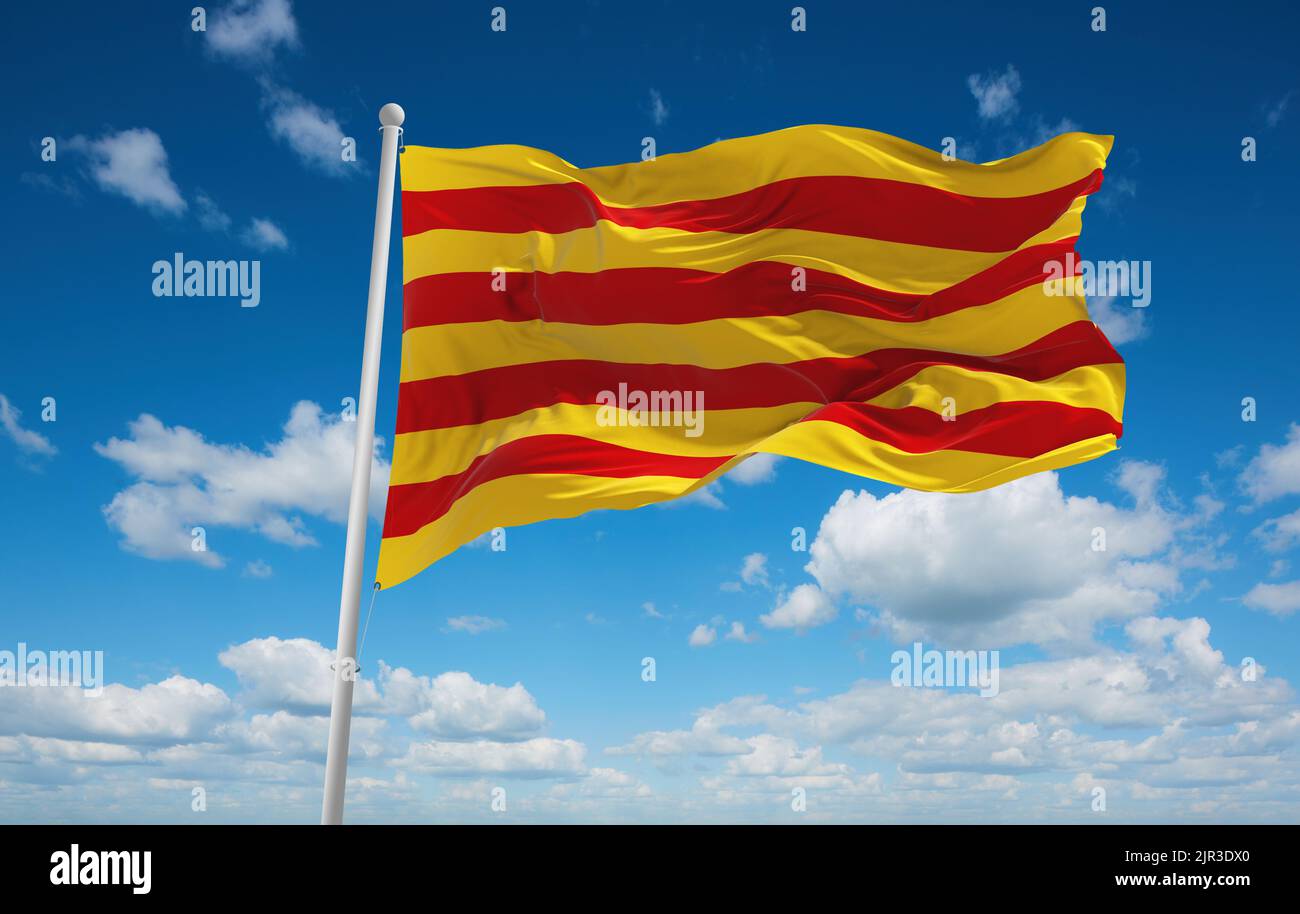 flag of Catalonia, Europe at cloudy sky background, panoramic view ...