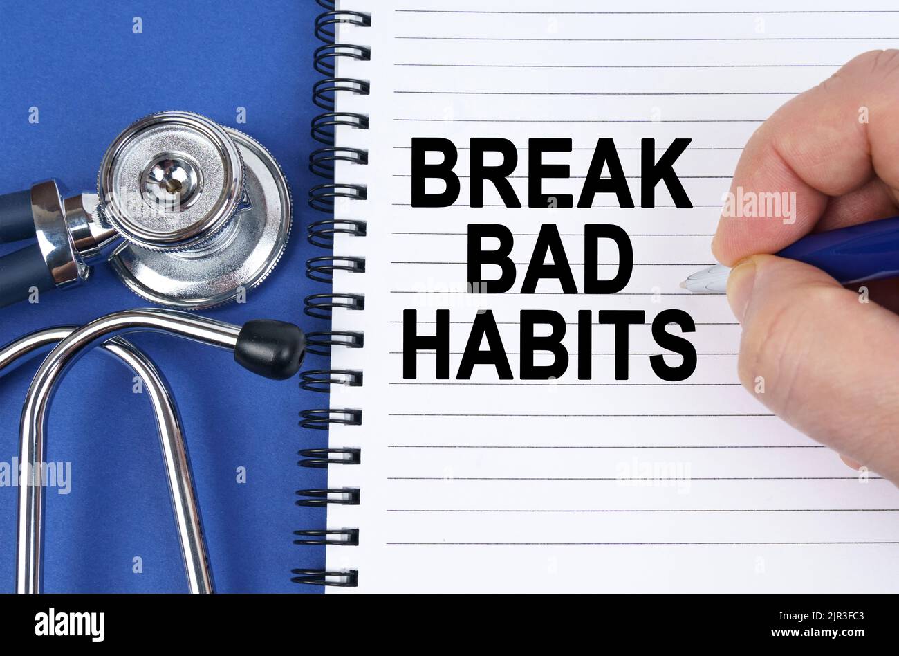 Medical concept. On a blue surface lies a stethoscope and a notebook in ...