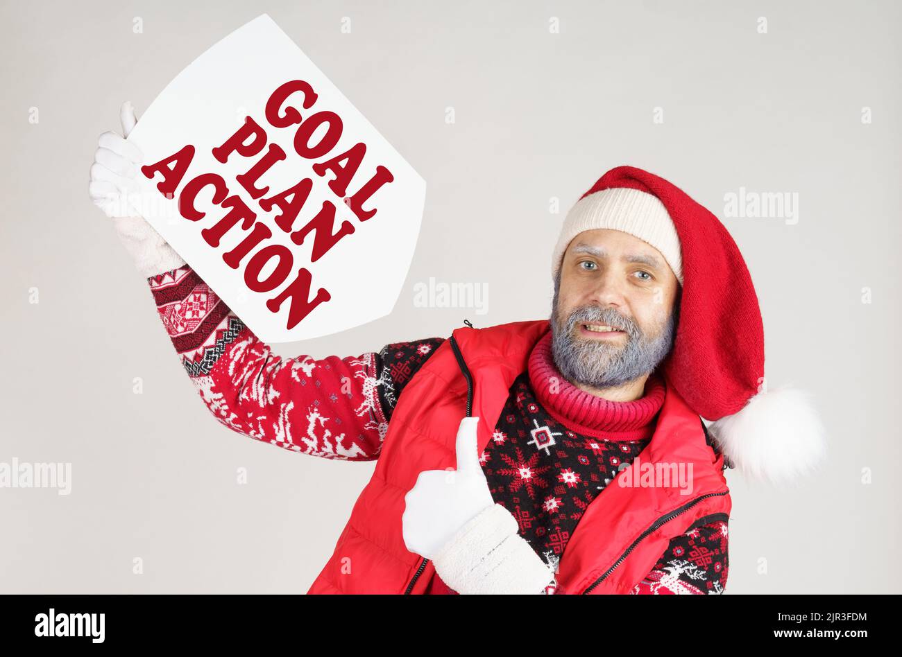 Concept of christmas and new year. Santa is holding a white sign with ...