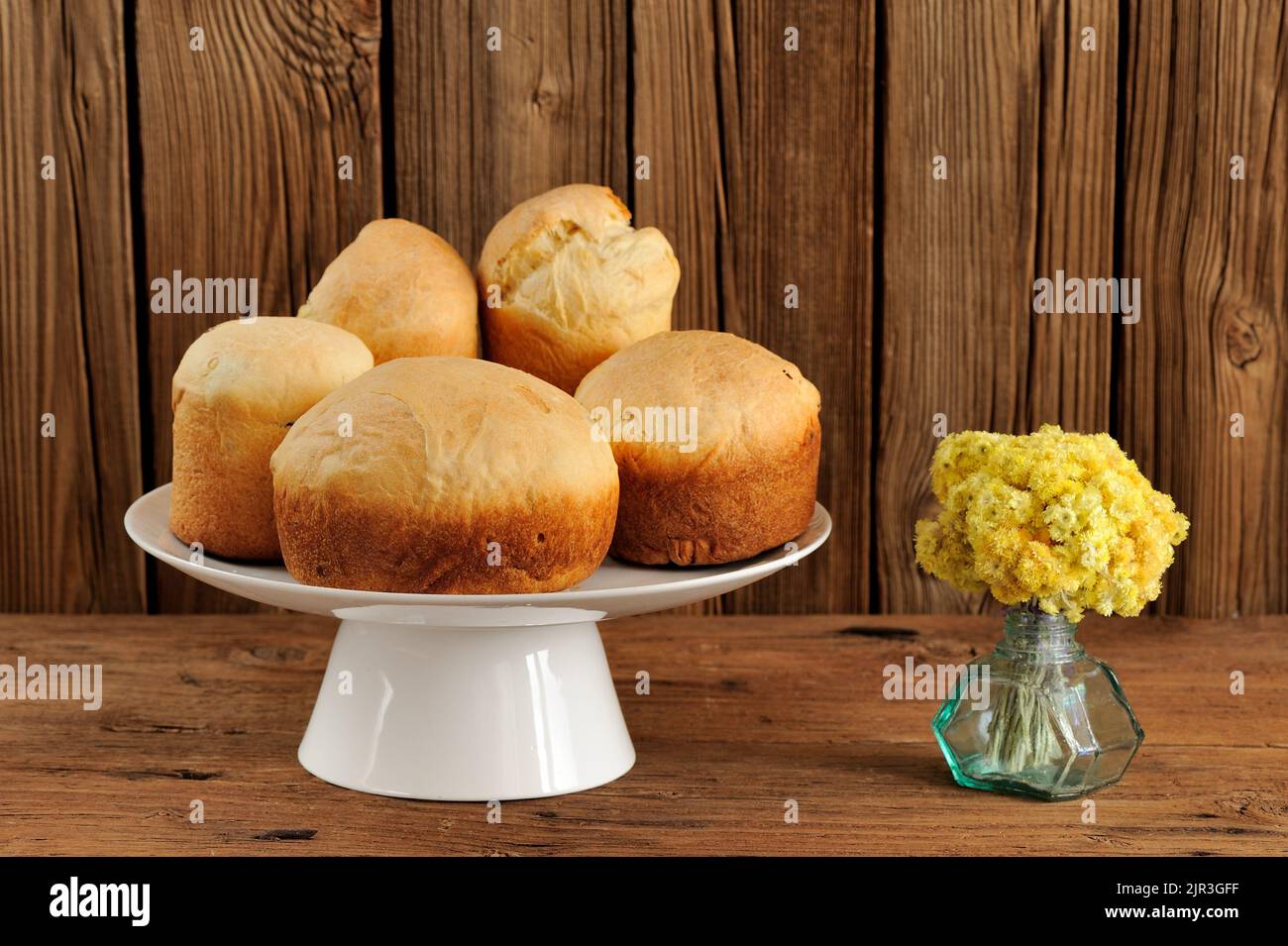 Paska, East European easter sweet breads on white pedestal with yellow ...