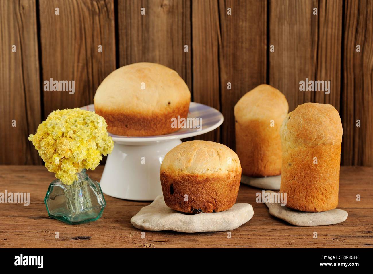 Paska, East European easter sweet breads with yellow flowers on wooden ...