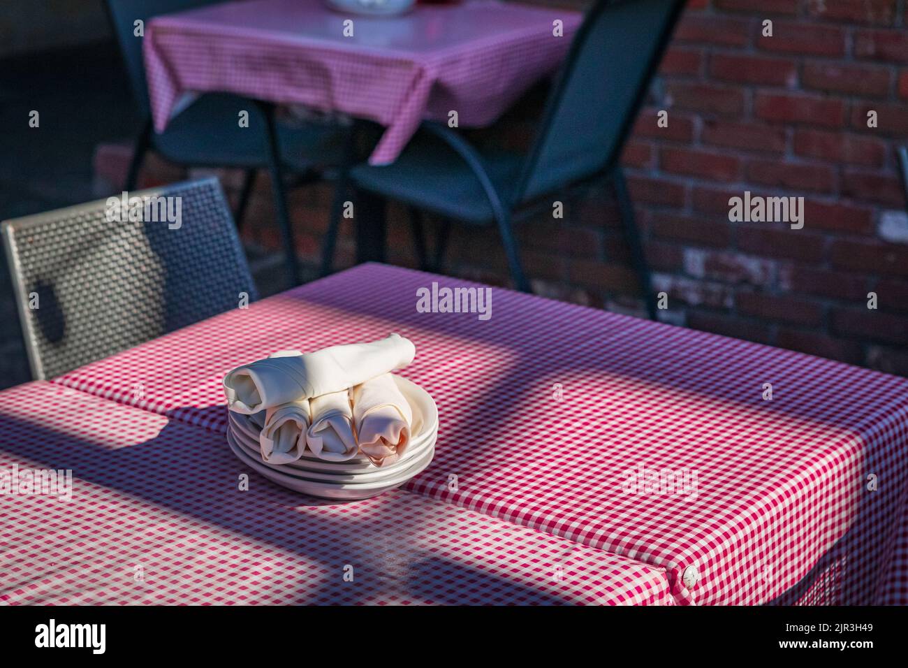 Street photo of a table and tablecloth in restaurant. Table setting in ...