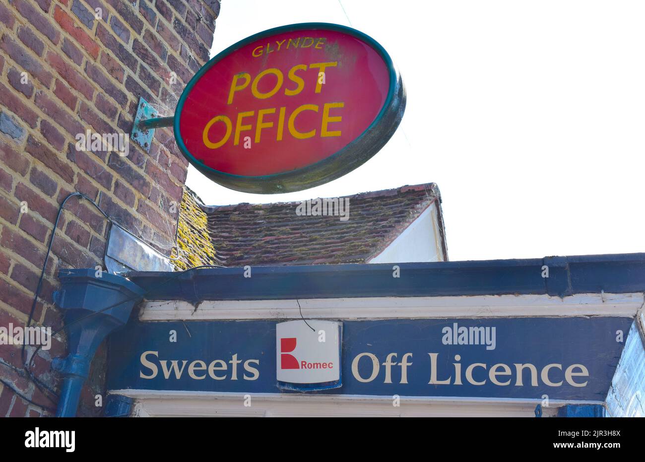 Off licence shop with post office sign in Glynde village England UK ...