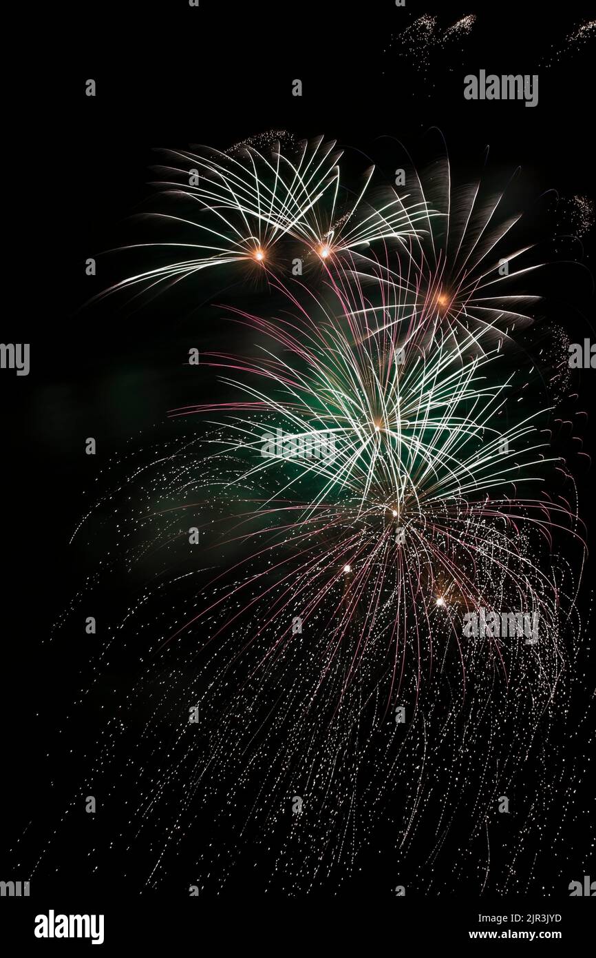 Red and white fireworks in the night sky Stock Photo - Alamy