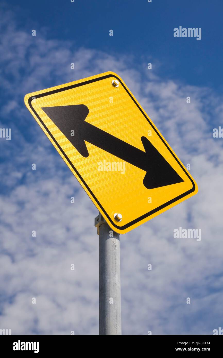 Yellow with double black left and right arrow direction sign against a ...