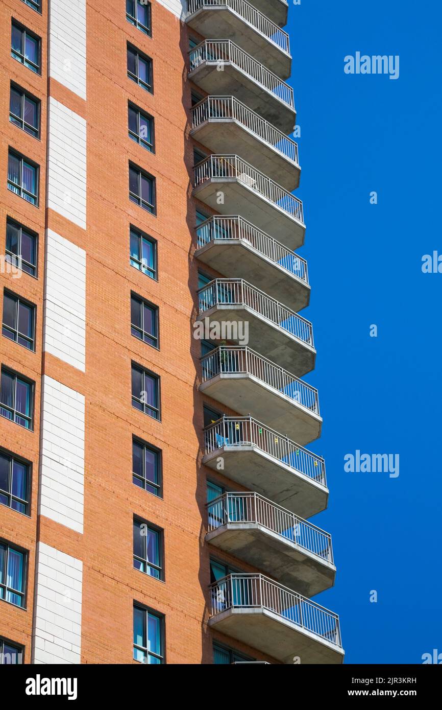 High-rise apartment building with balconies fitted security railing ...