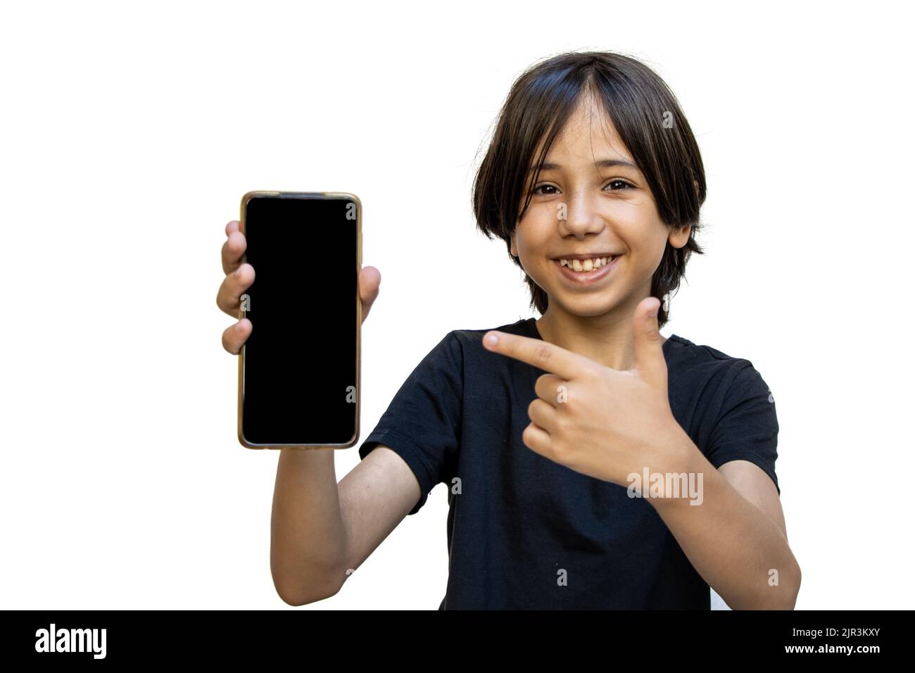 Smiling young asian boy holds a smartphone in his hand and shows his ...