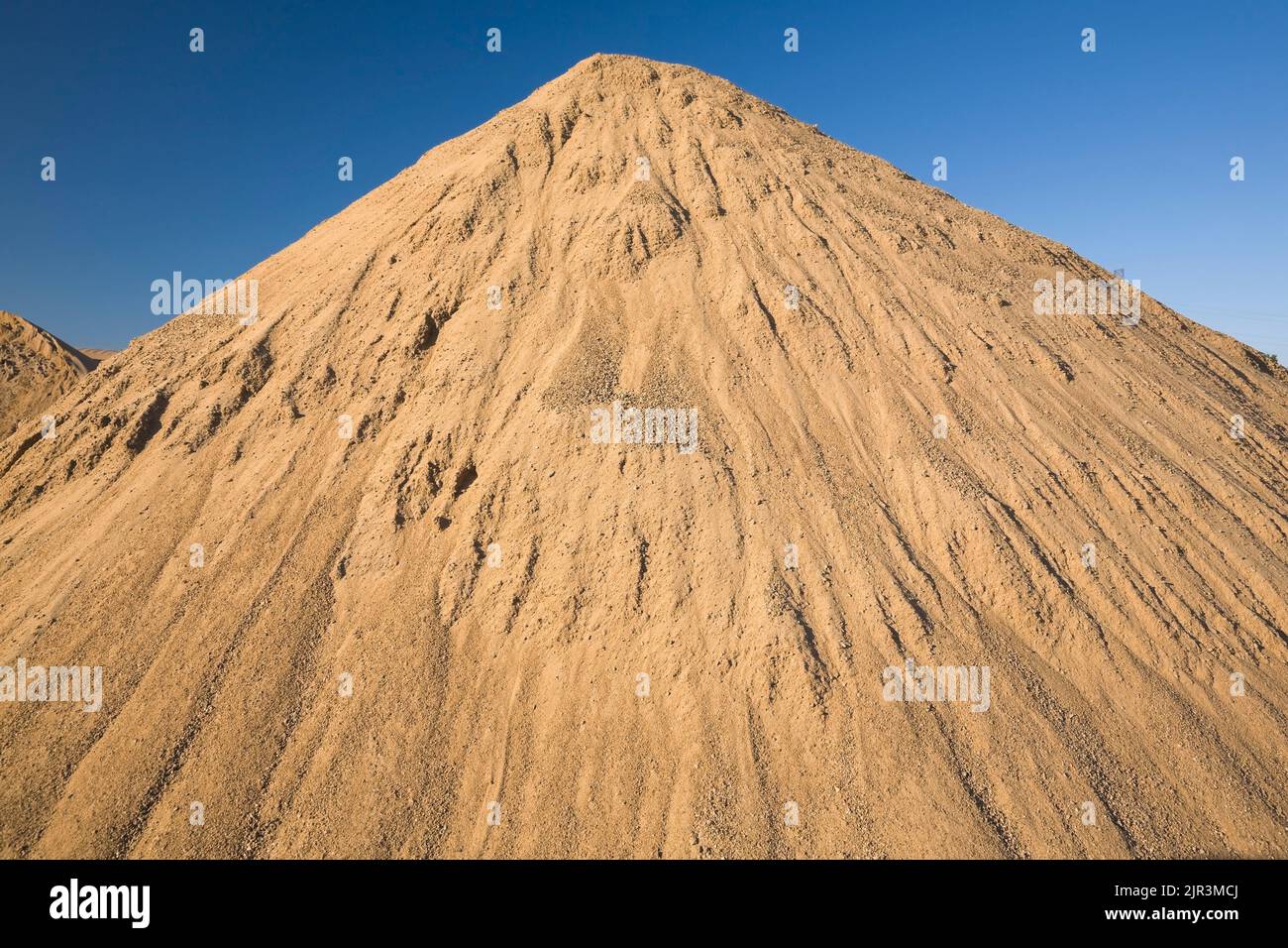 Large mound of stacked tan colored sand in a commercial sandpit Stock ...