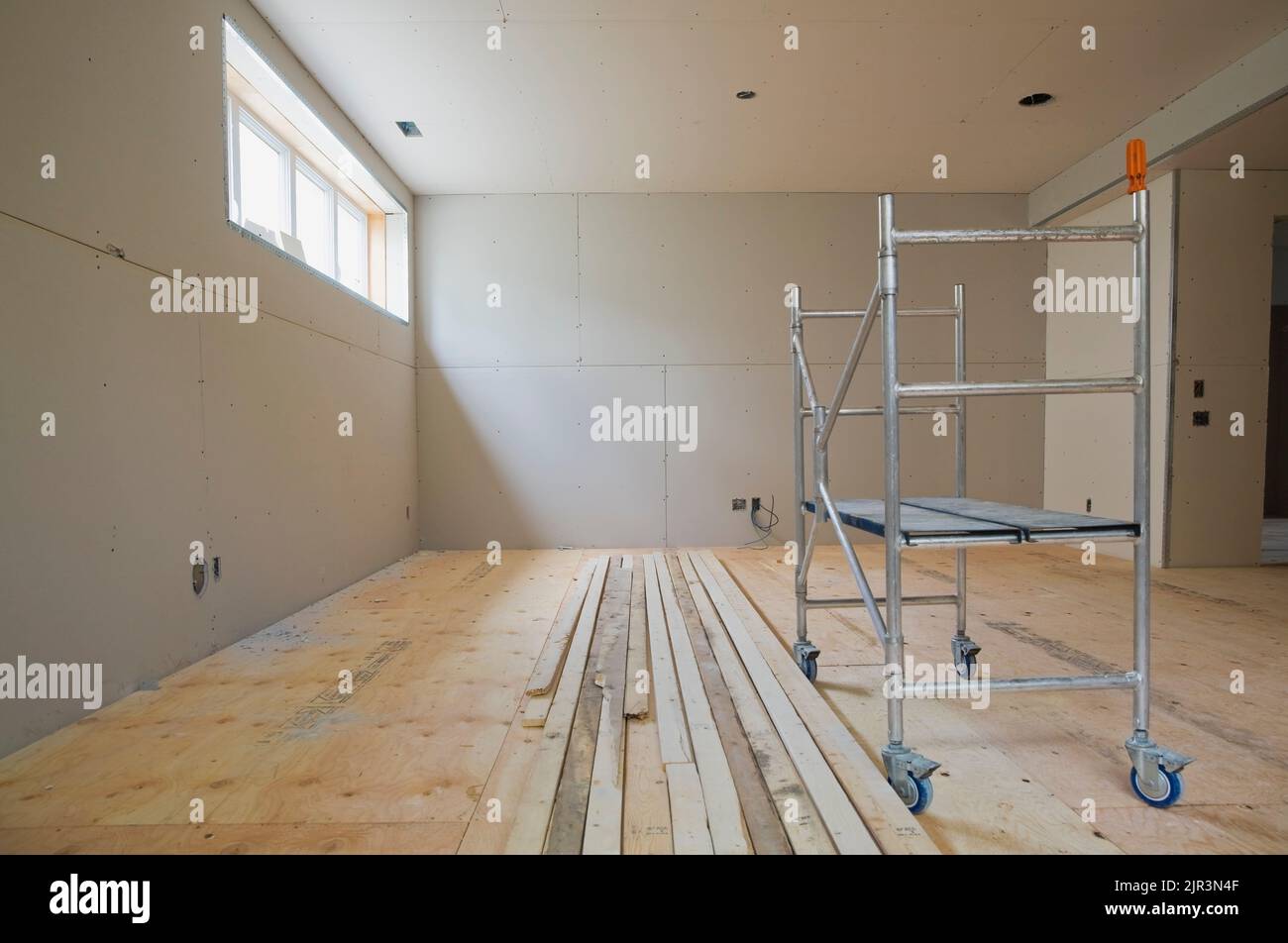 Unfinished basement room with unpainted drywall inside upscale ...