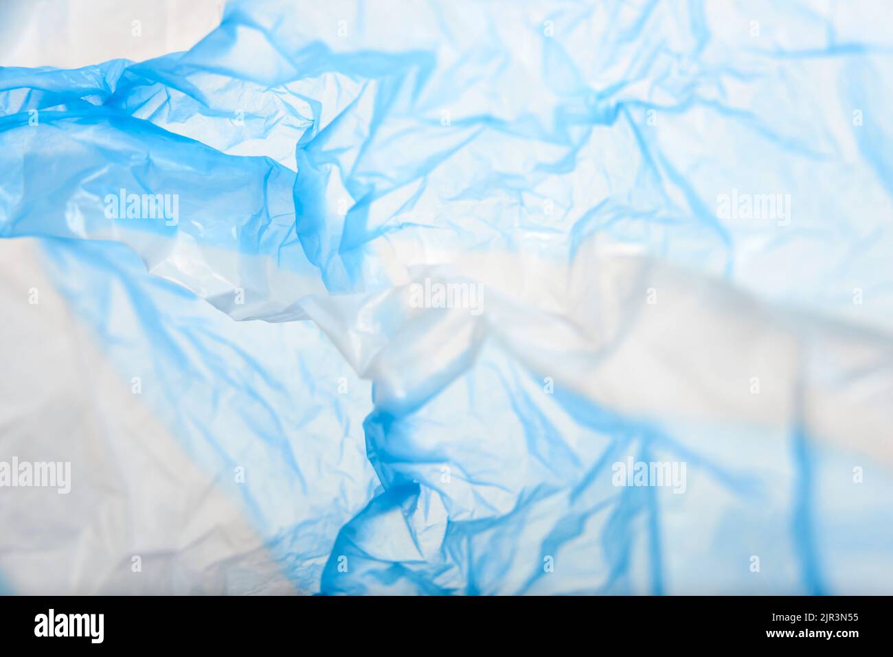 White and blue plastic background, wrinkled single use bag. Concepts ...
