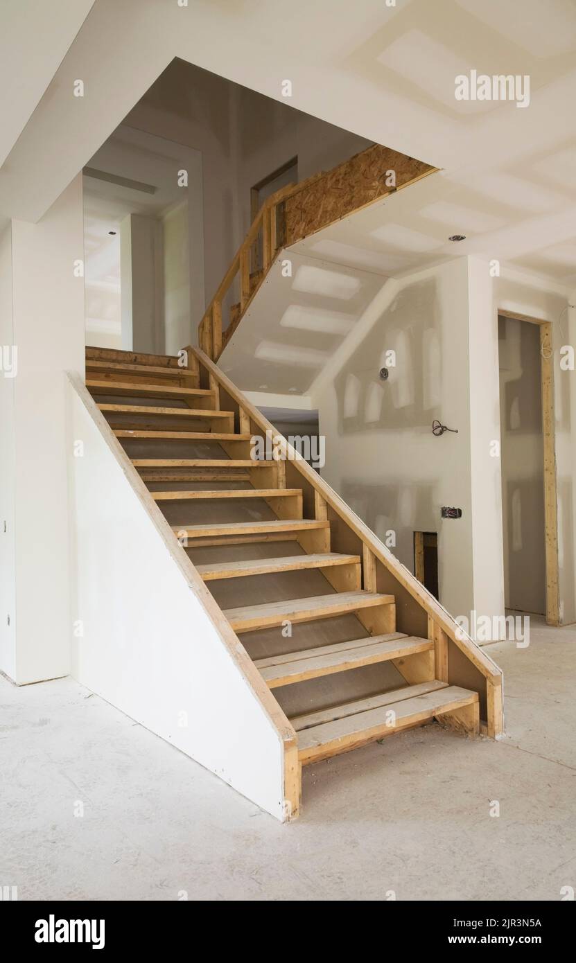 Unfinished staircase and unpainted drywall ready to be painted in ...