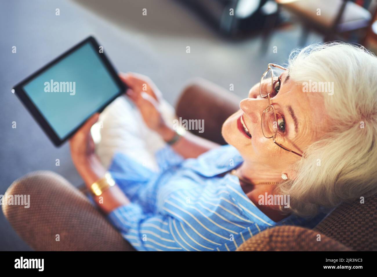 Technology made accessible for any age. a senior woman using a tablet ...