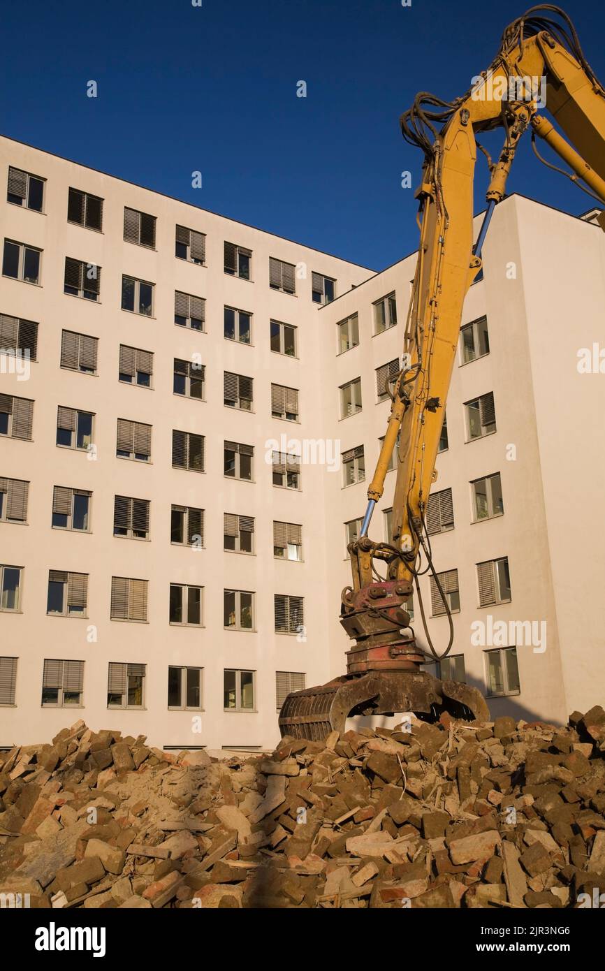 Pile of debris and work crane in front of a modern architectural ...