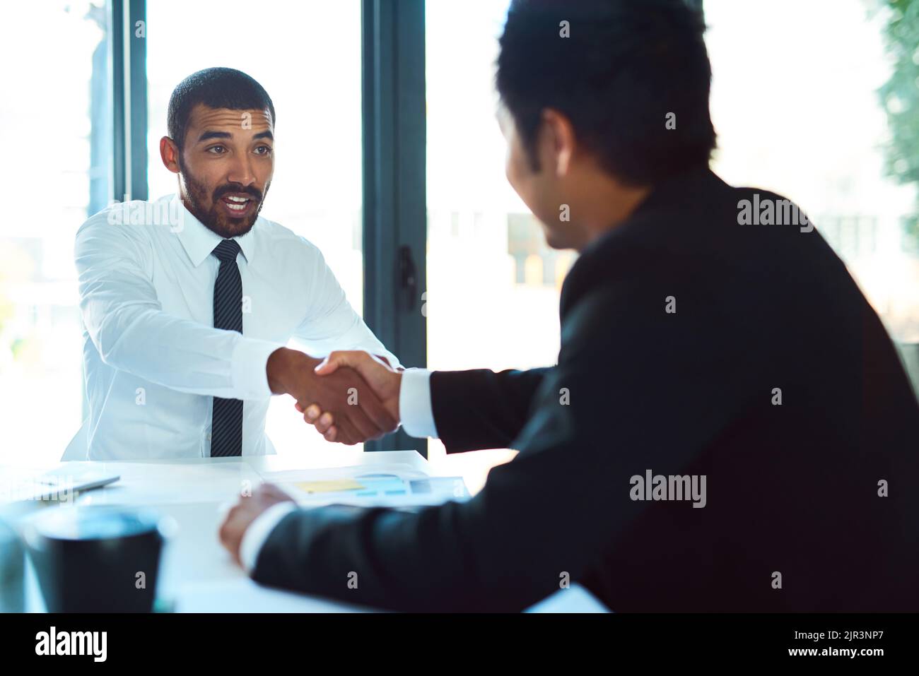 Glad to have you on our team. a two businessmen shaking hands in the ...