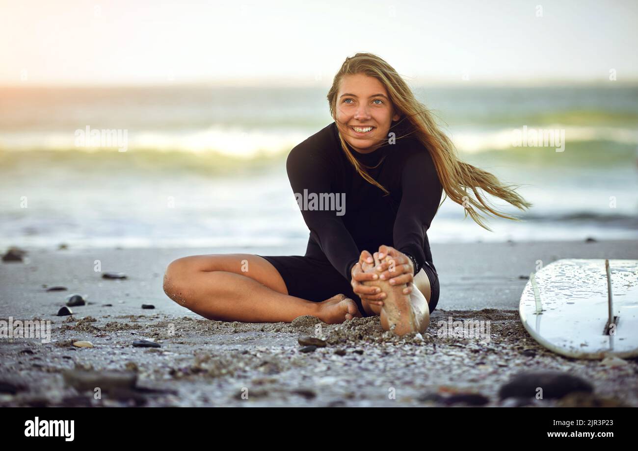Getting ready for a surf. Full length shot of an attractive young ...