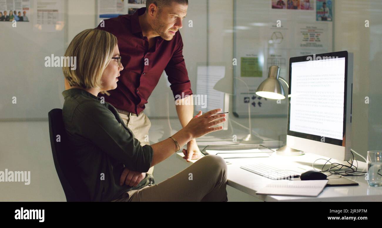 Working it out together. two businesspeople working together on a ...