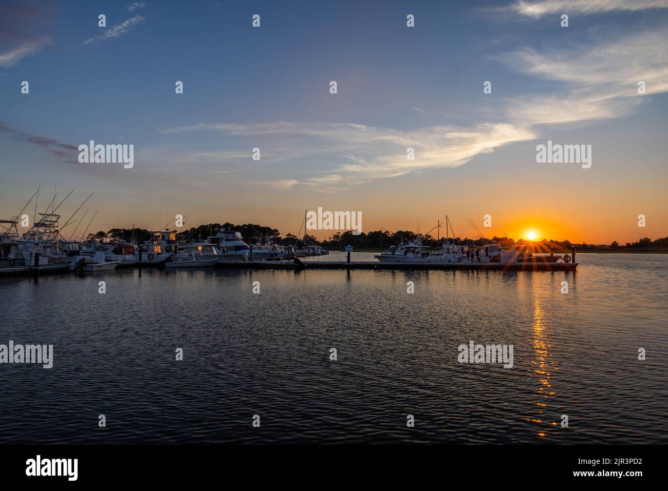 Setting sun, Indian River Marina, Delaware Seashore State Park ...