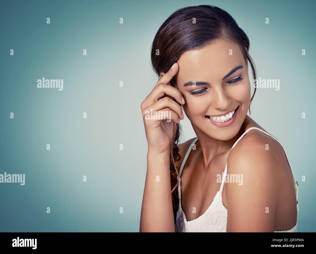 She is so stunning yet still so shy. Studio shot of a beautiful young ...