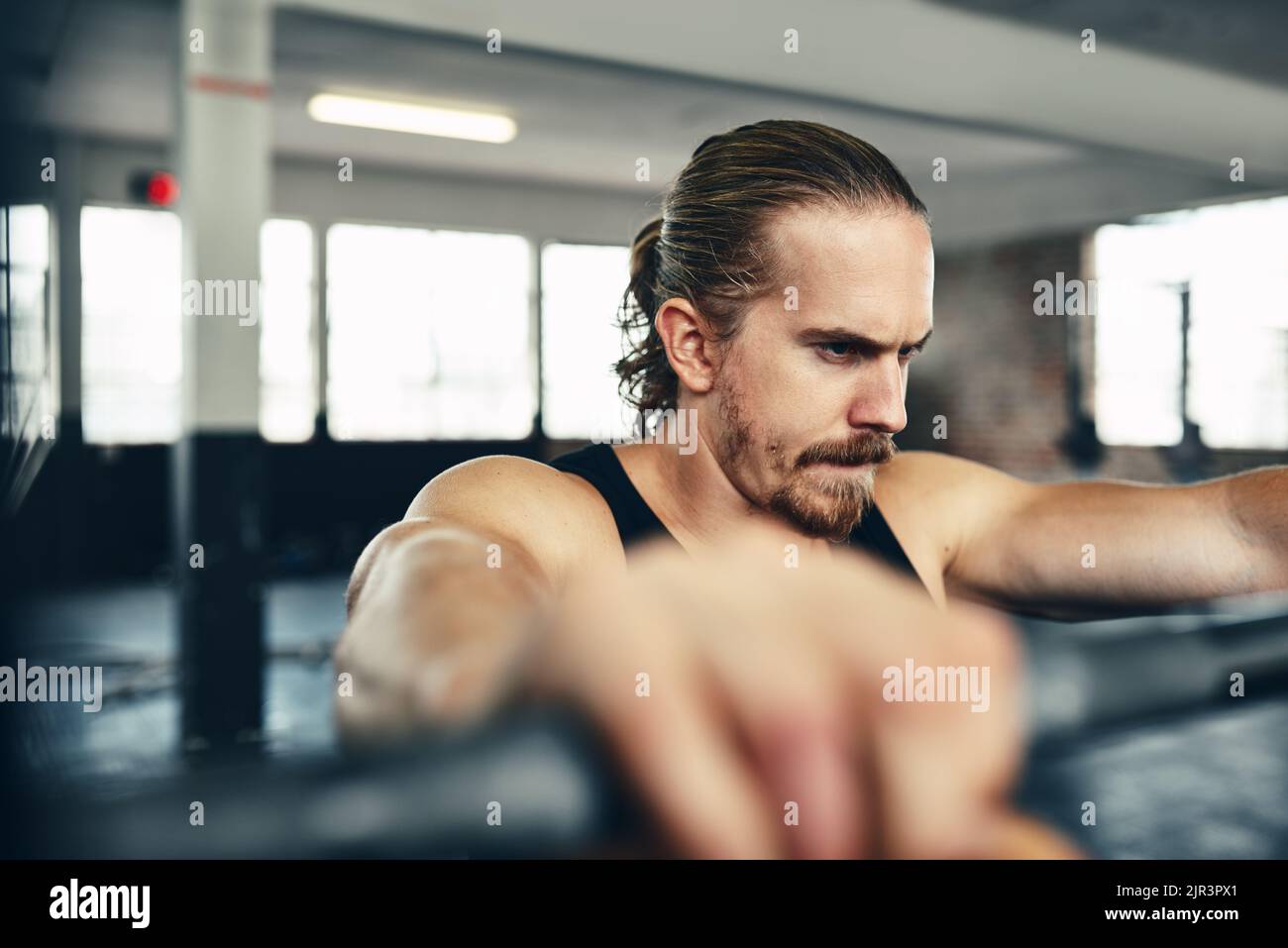 Focus on the weights you lift, not weight you lose. a man lifting ...