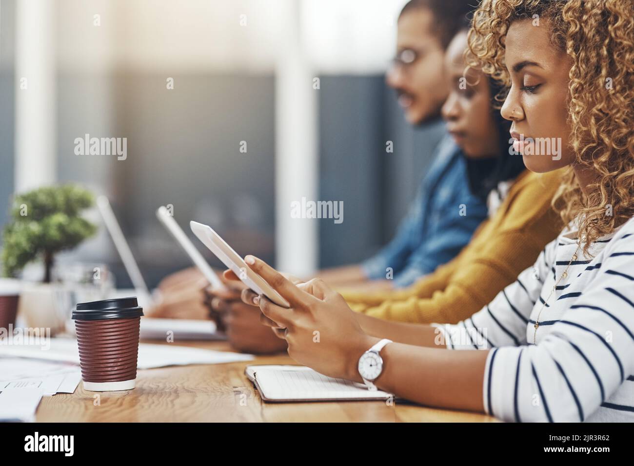 Working in a wireless environment. colleagues using digital tablets ...