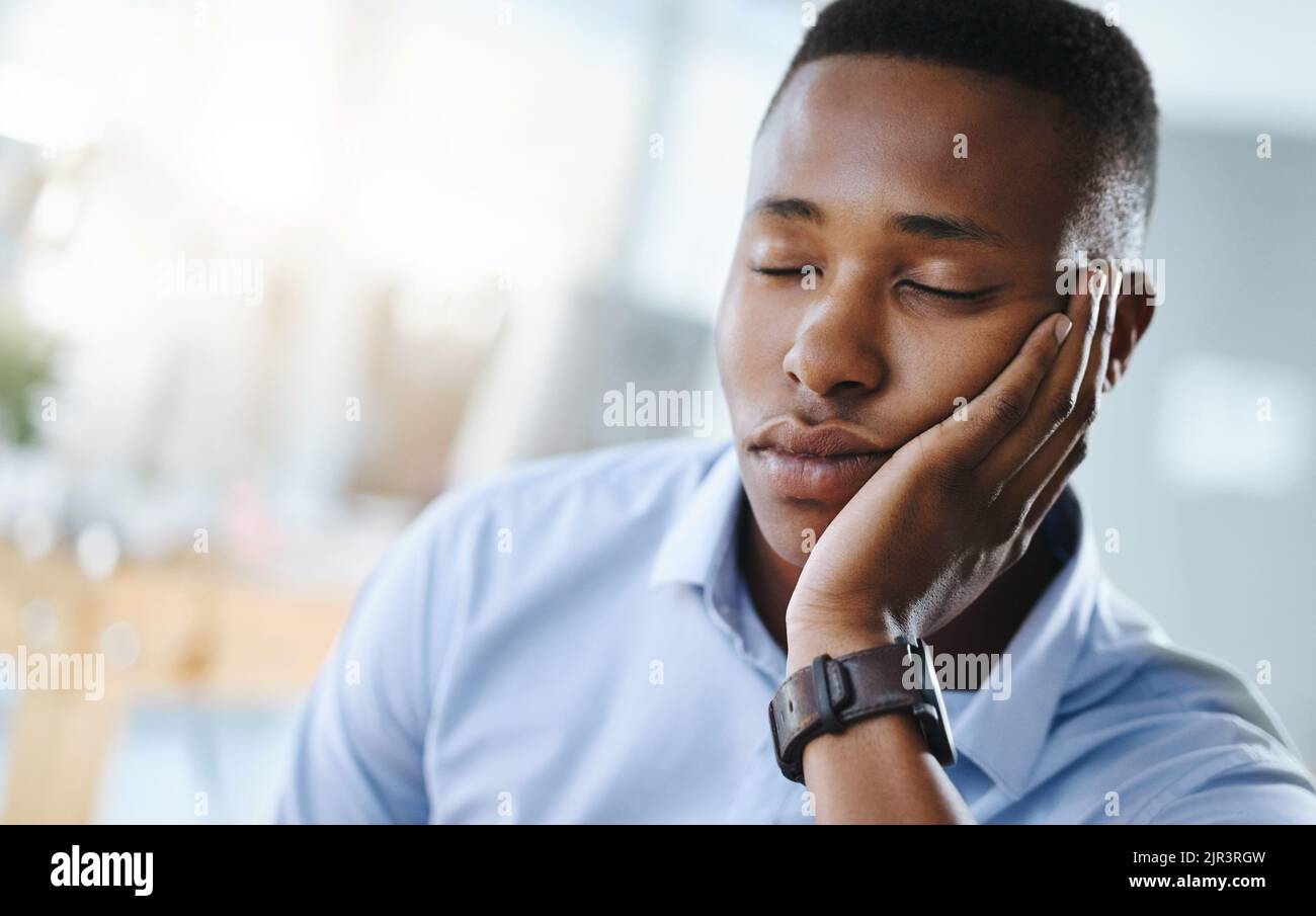 This day has got me tired. a young and tired businessman having a quick ...