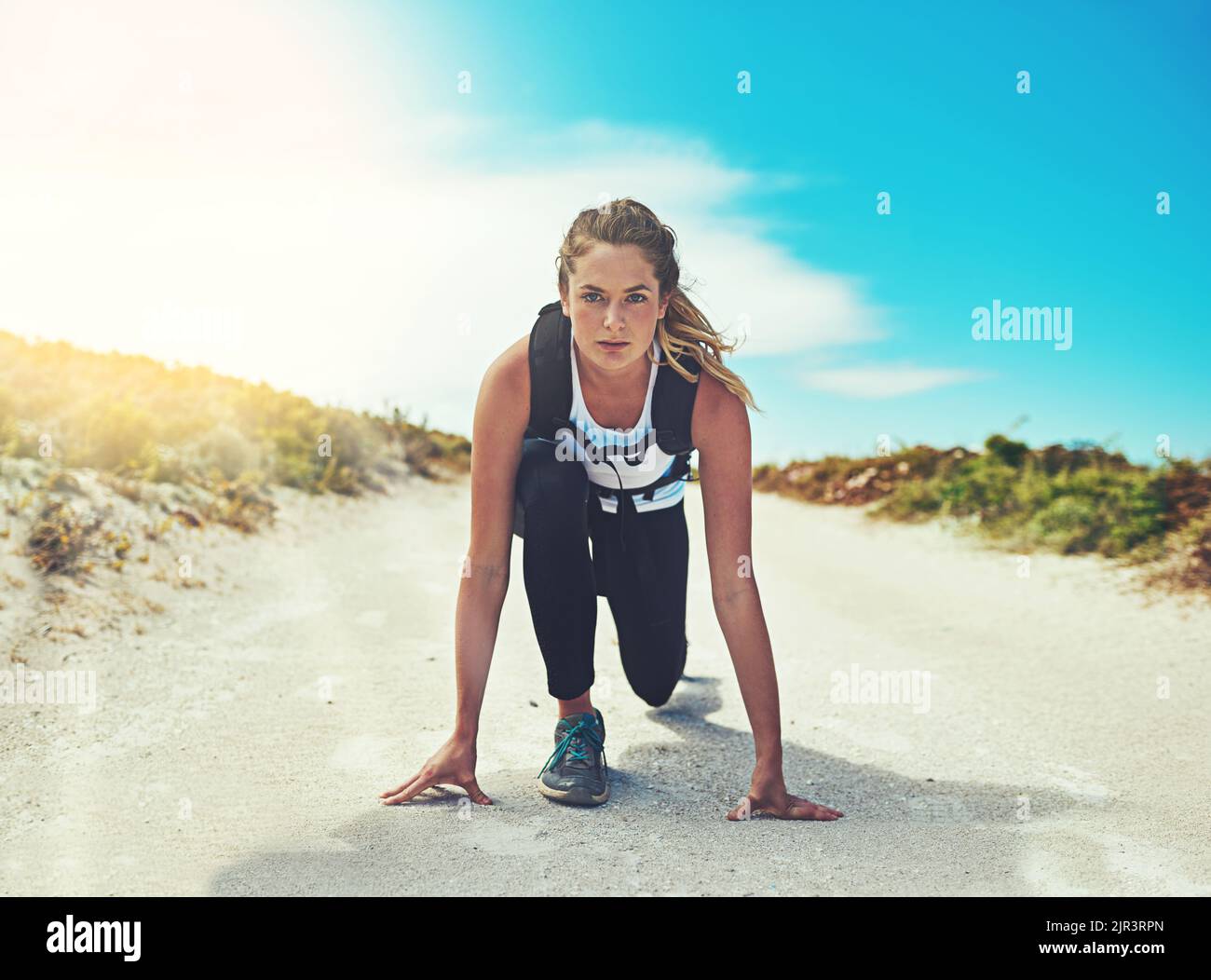 Ready, set, go time to exercise. a sporty young woman getting ready to ...