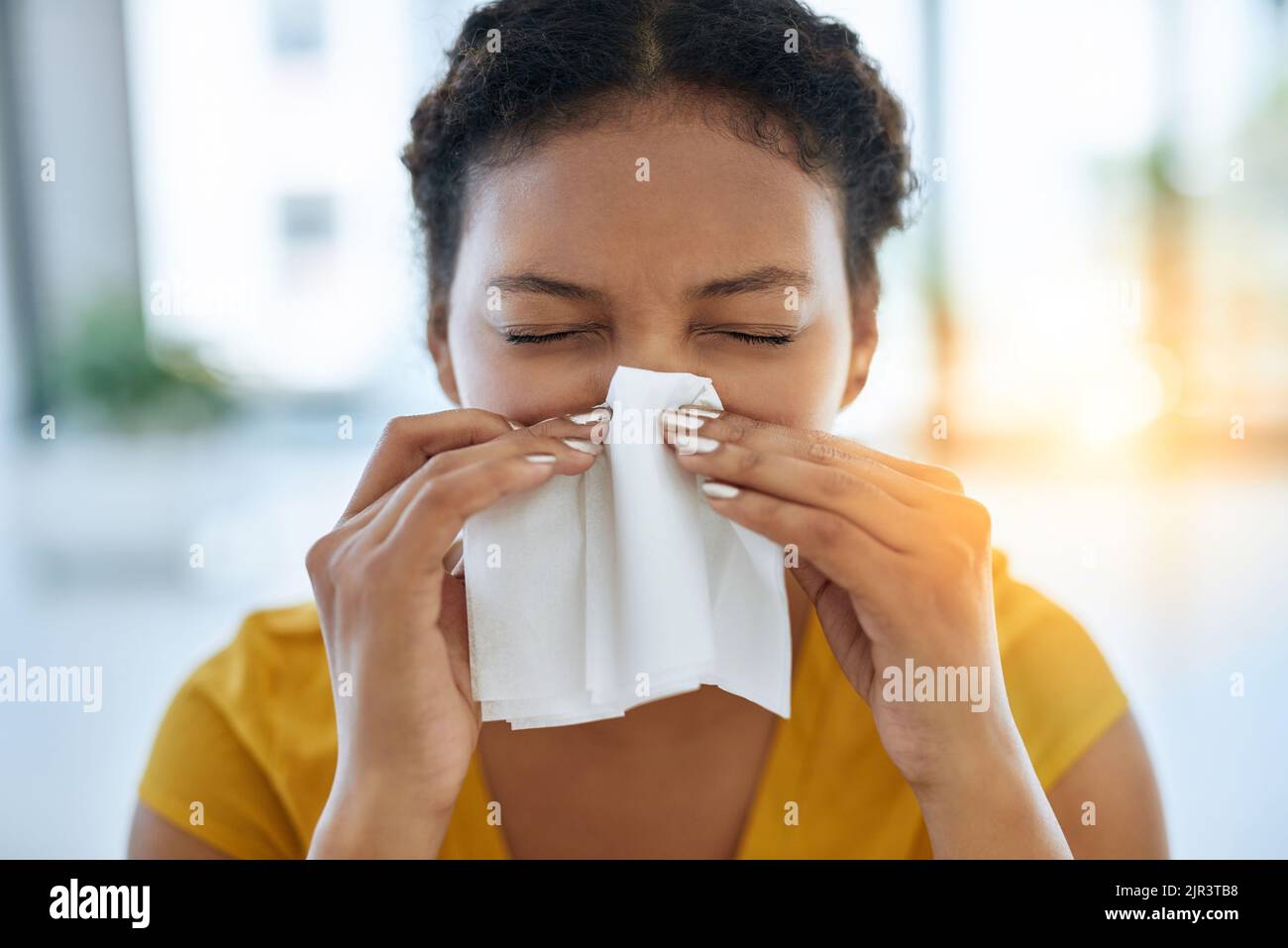 I might need more tissues than just this one. a young designer blowing ...