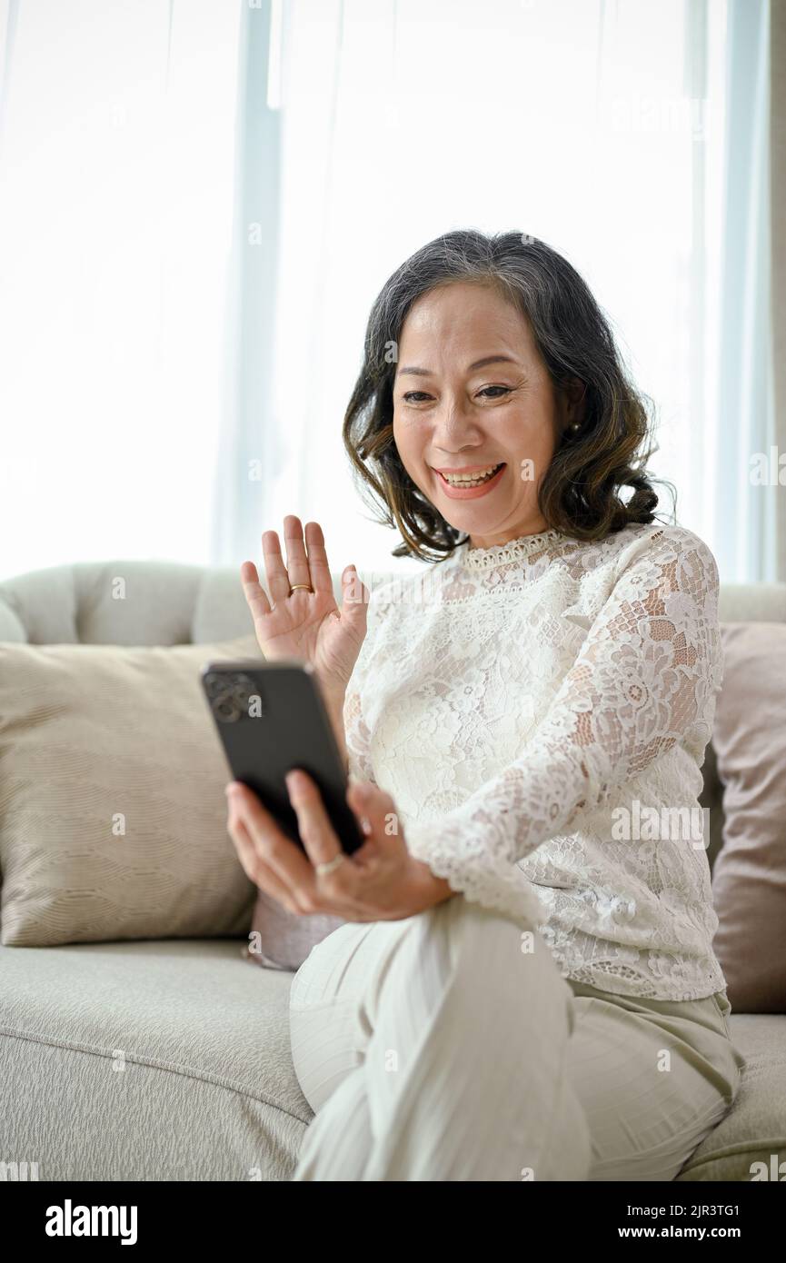 Portrait Happy Asian Middle Aged Woman Uses Her Smartphone To Video