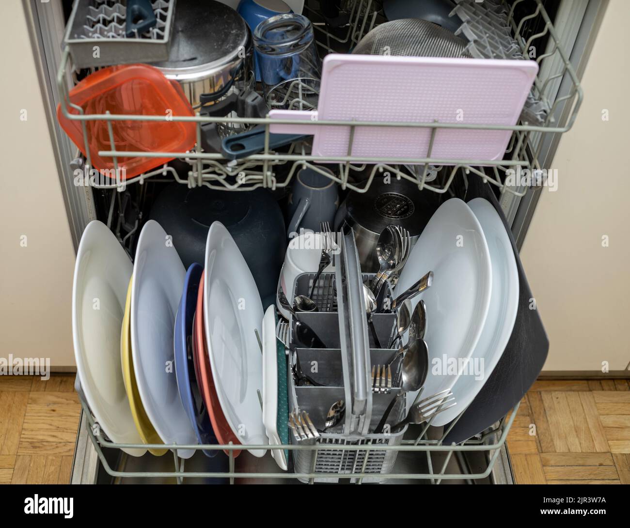 open dishwasher with clean dishes, utensils and pots Stock Photo - Alamy