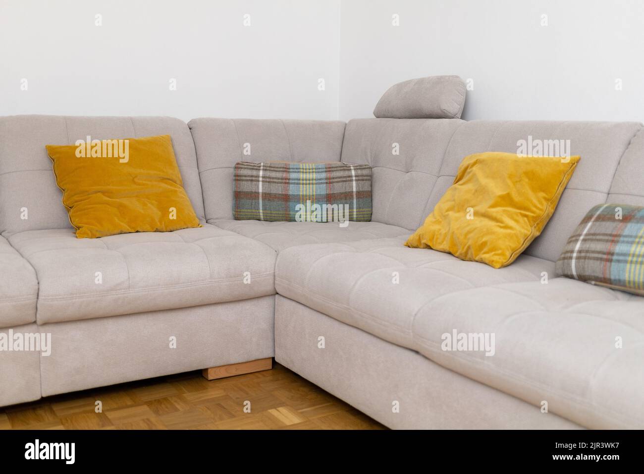 interior corner soft sofa with yellow pillows Stock Photo - Alamy