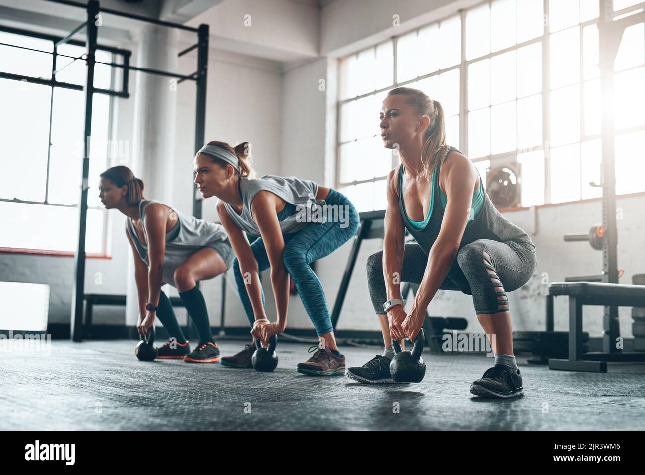 Keep going with your fitness goals. three young women working out ...