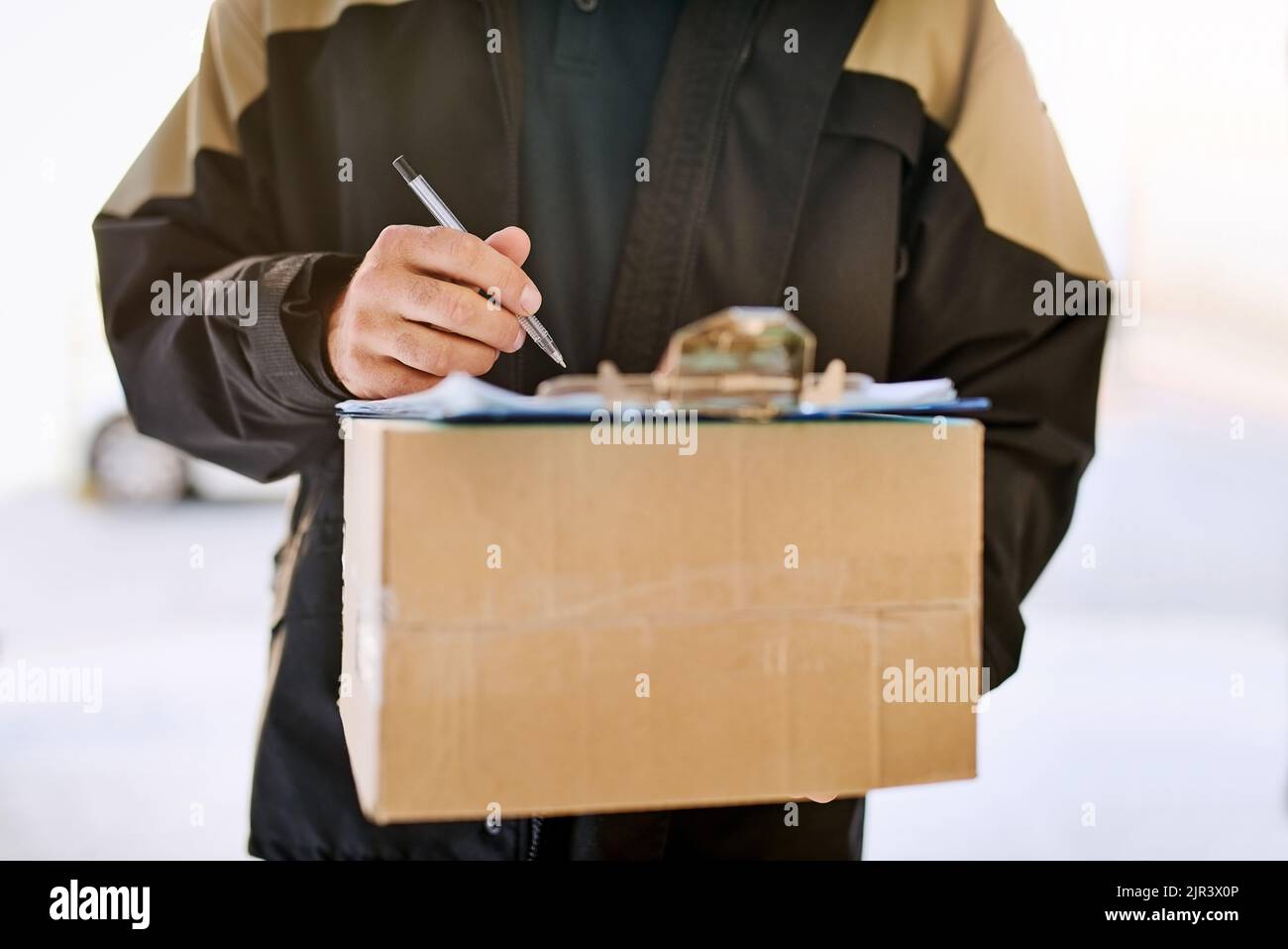 Your delivery is on its way to you. a courier holding a box and ...