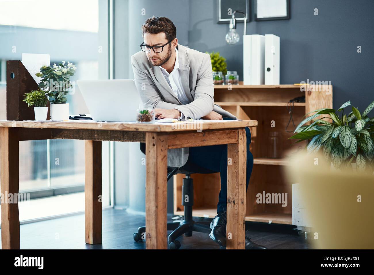 Focused on getting business done. a young businessman working on a ...