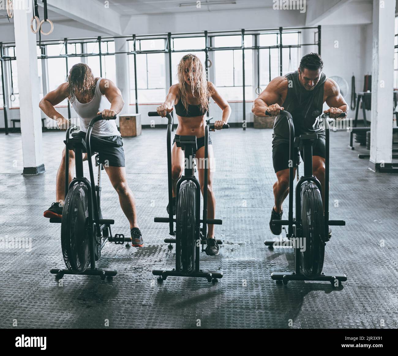 Wish less and work more. three people working out on elliptical ...