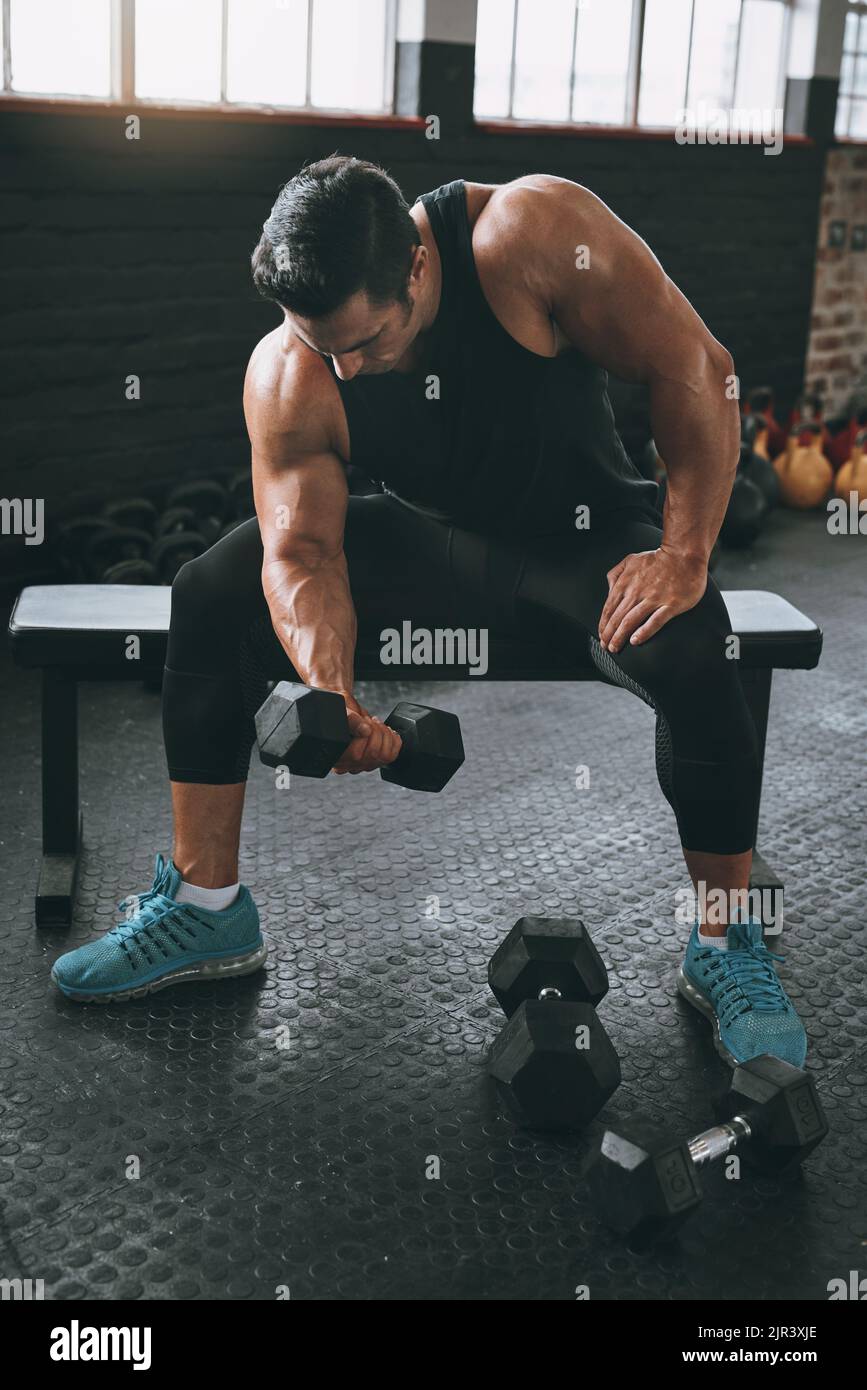 Im the result of my dedication. a young man working out with dumbbells ...