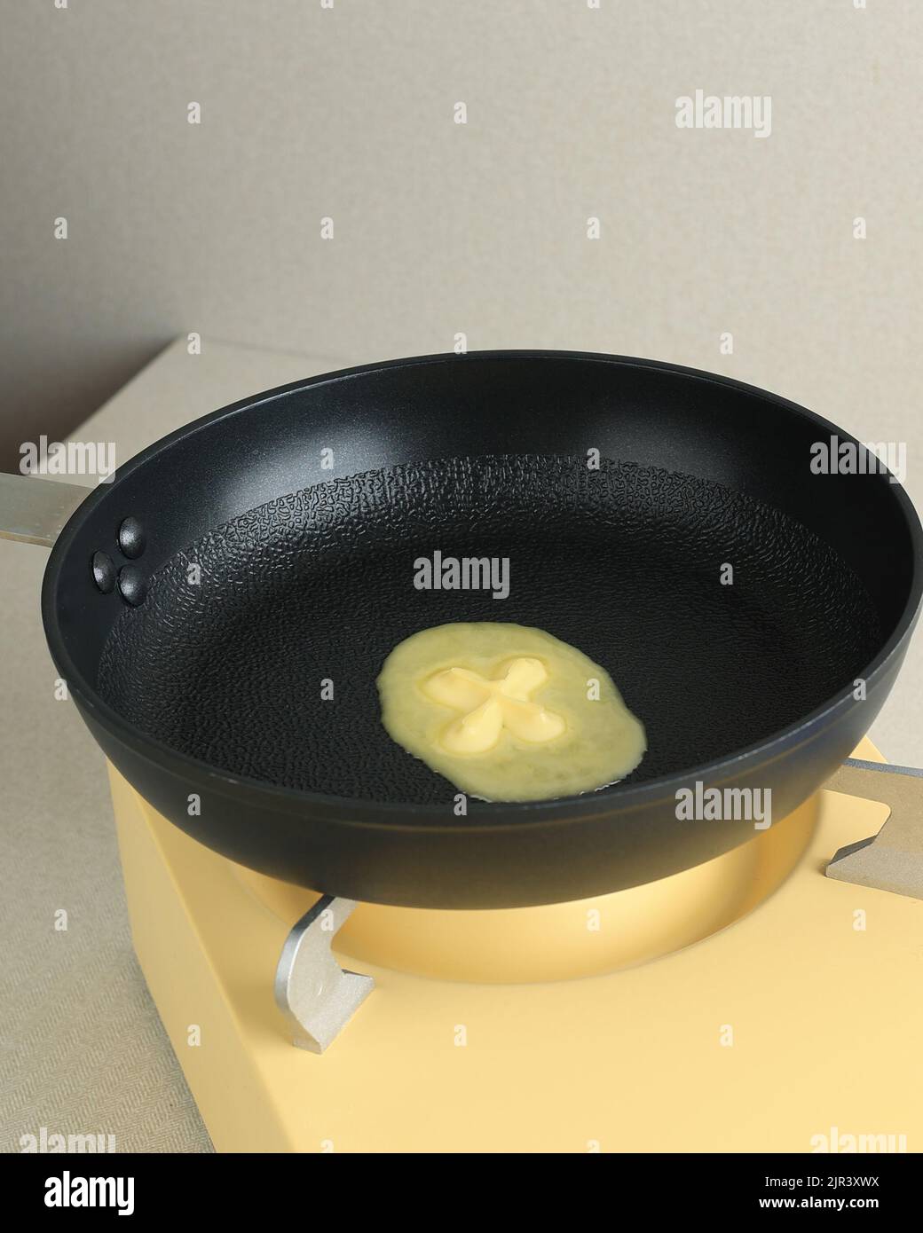Melted Butter on Black Skillet Pan Above Portable Stove Stock Photo - Alamy