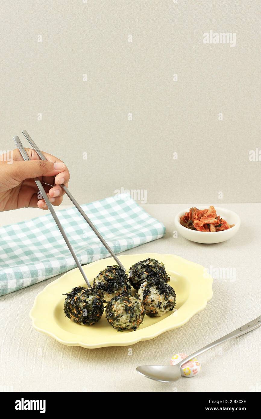Hand holding rice ball hi-res stock photography and images - Alamy