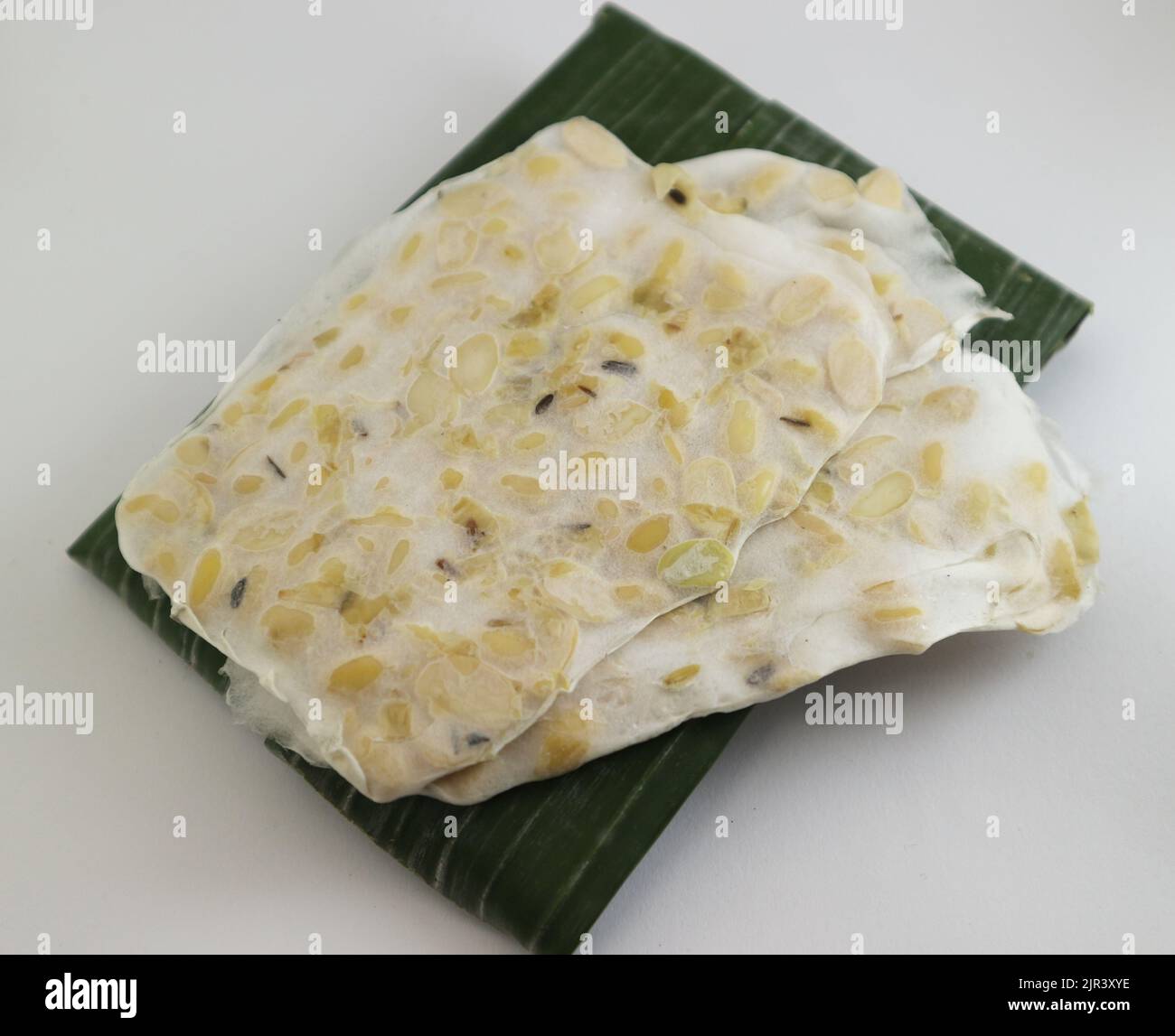 Raw tempeh in the white background Stock Photo - Alamy