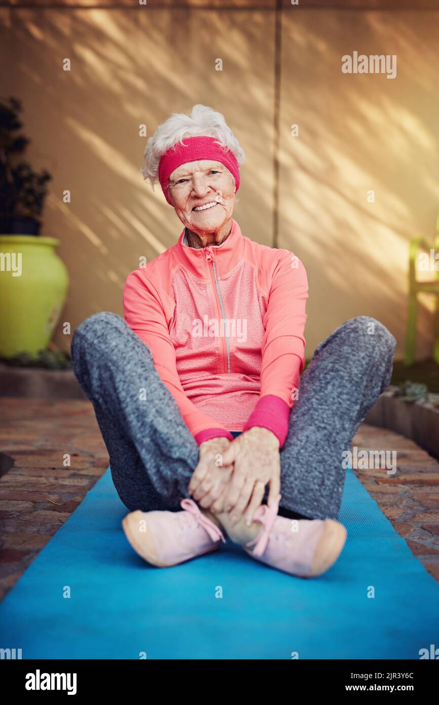 Growing old became easy due to fitness. a senior woman exercising at ...