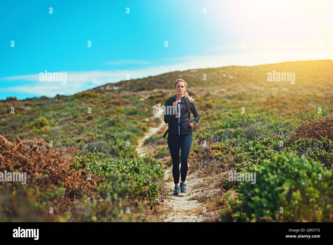 Early run to have later fun. a sporty young woman exercising outdoors ...