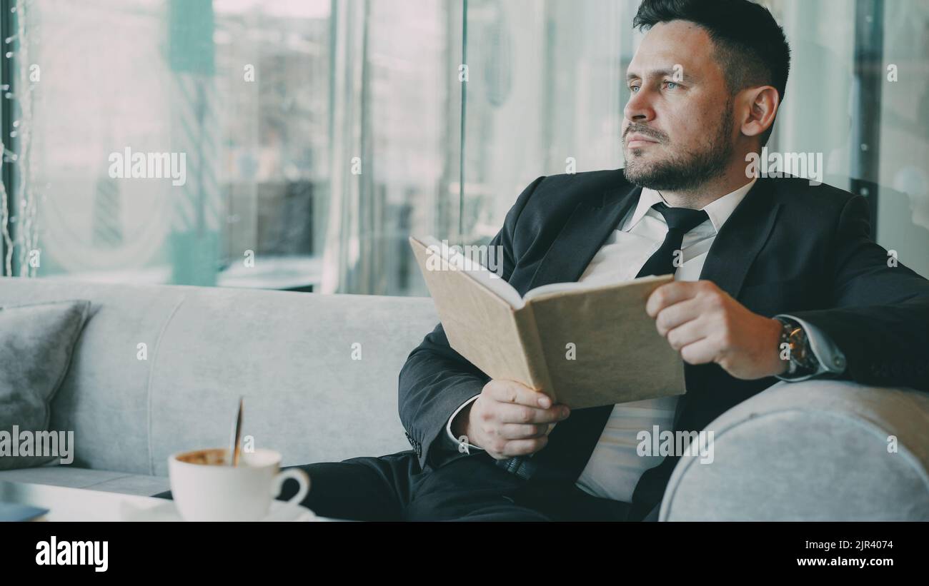 Successful Smart Caucasian businessman in formal clothes reading text ...