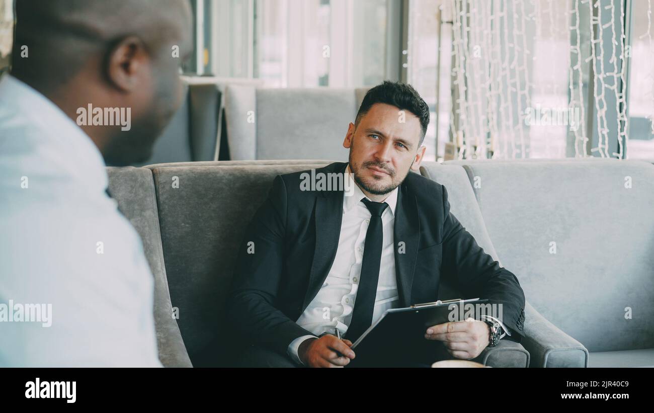 HR businessman having job interview with african american man and ...
