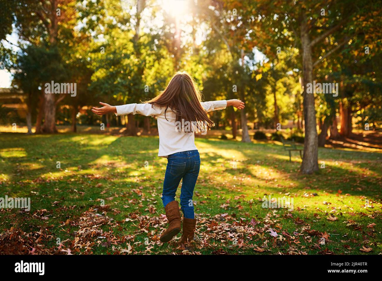 Autumn is awesome. a happy little girl playing in the autumn leaves ...