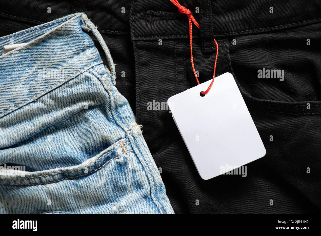 womens denim shorts with white blank paper price tag for text on table ...