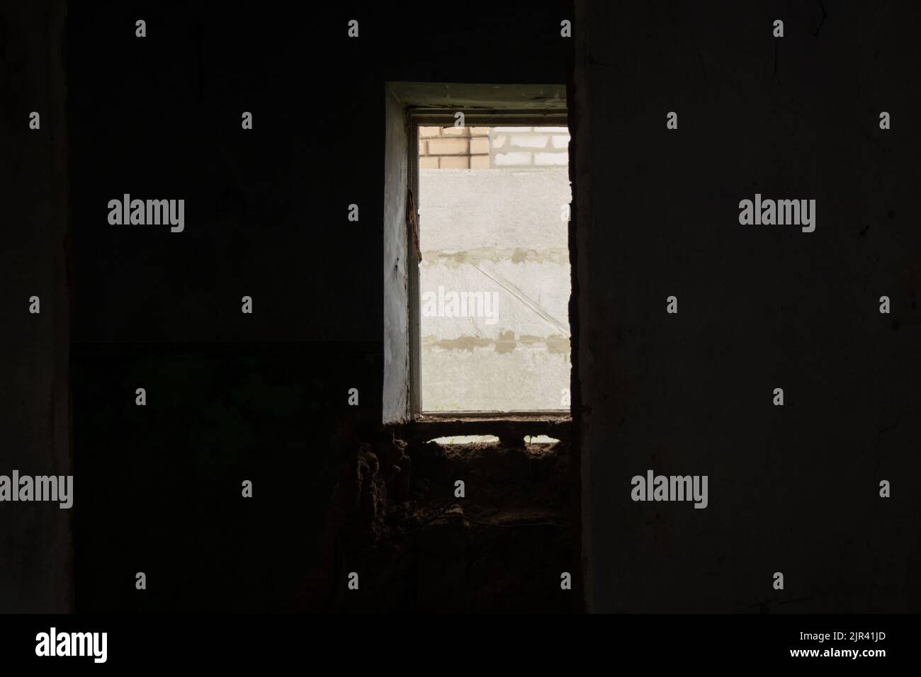 old abandoned one-story building dark without windows and doors ...