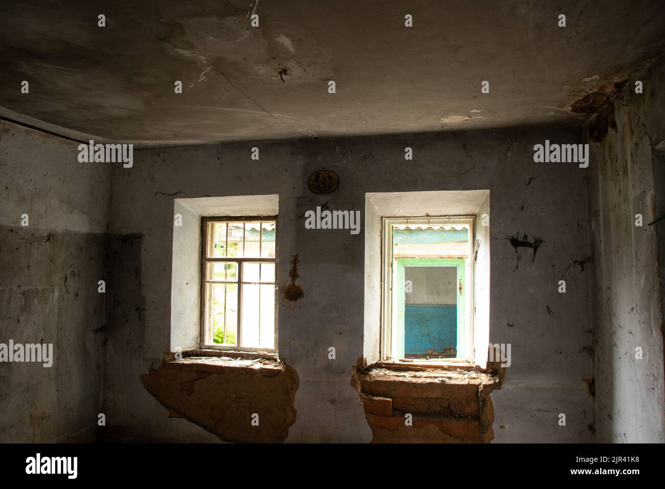 old abandoned one-story building dark without windows and doors, destroyed building in Ukraine ...