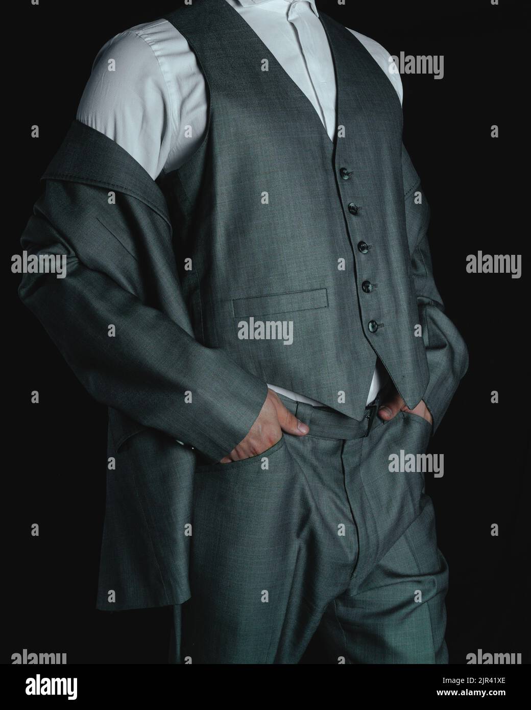Body of a man in a gray suit. Elegant gray suit. Business man posing on ...